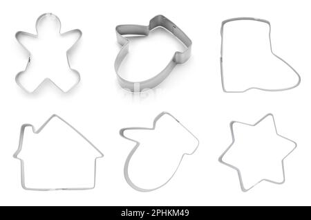 Set with cookie cutters of different shapes on white background, top ...