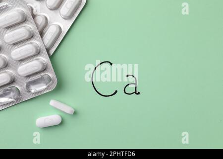 Blister packs with calcium supplement pills on light blue background ...