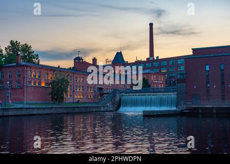 Sunset view of brick buildings alongside Tammerkoski channel in Tampere ...