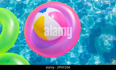 Inflatable pool ball on lifebuoy in the pool Stock Photo - Alamy