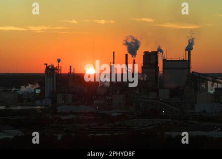 Huge factory with high chimneys polluting atmosphere with carbon ...