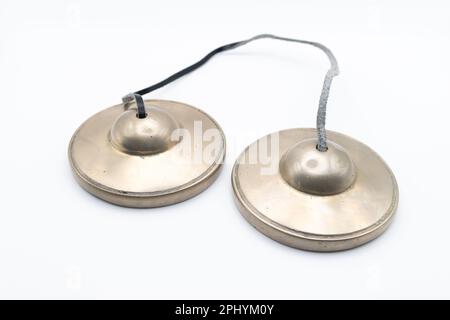 Tibetan Buddhist tingsha (tibetan cymbals) with leather strap isolated ...