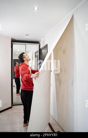 Repair the house with their own hands. The guy is ripping the old ...