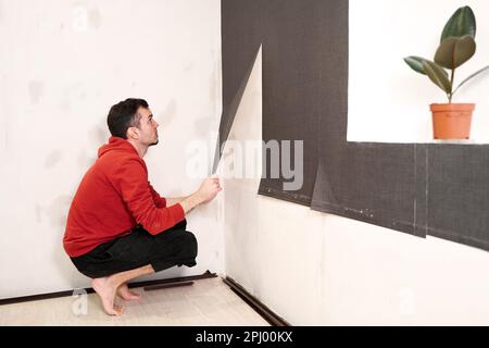 Repair the house with their own hands. The guy is ripping the old ...