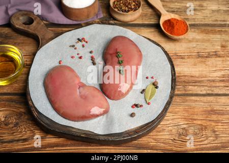 Fresh raw pork kidneys and ingredients on white marble table, space for ...