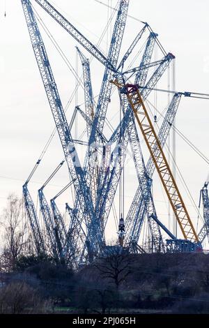 Construction cranes and jibs in different shapes Factory premises of ...