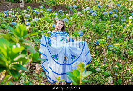 Young Nicaraguan woman in traditional folk costume in the field ...