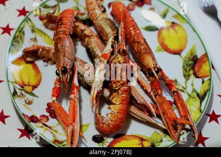 Scampi (Nephrops norvegicus) cooked in a cast iron pan. Fresh shellfish ...