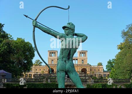 The statue of an archer in front of the Orangery in the grounds of ...