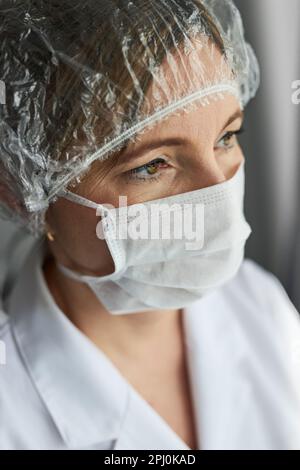 Young doctor wearing medical uniform over isolated background shouting ...