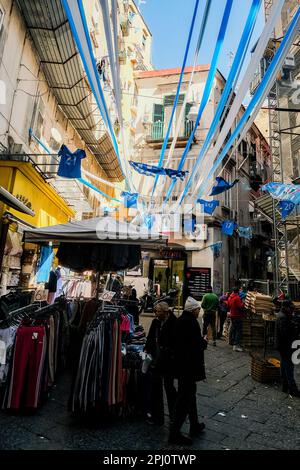 People pass under Banners and ribbons with the colors of the SSC Napoli ...