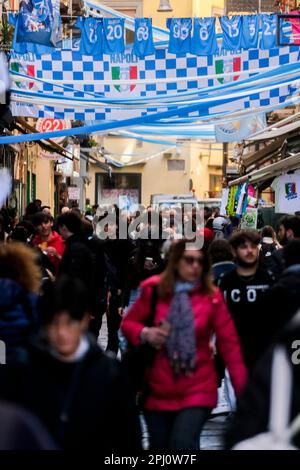 People pass under Banners and ribbons with the colors of the SSC Napoli ...