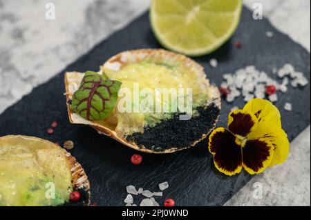 Delicacy roasted scallops with cheese spices and chuka algae Stock ...