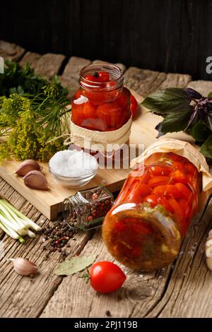 Marinated tomatoes with spices in an old tray. On a wooden background ...