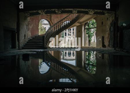 Old flooded abandoned mansion with spiral stair, water reflection Stock ...