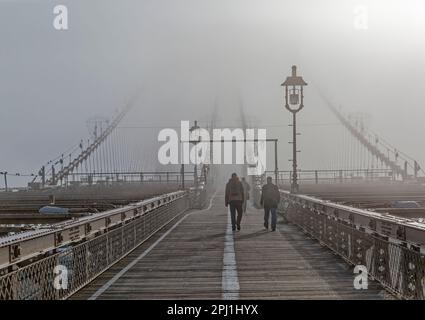 Brooklyn Bridge’s famous gothic towers are shrouded in a January fog ...