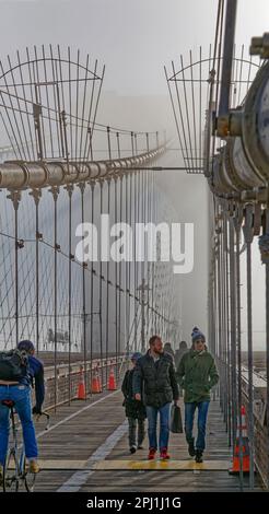 Brooklyn Bridge’s famous gothic towers are shrouded in a January fog ...