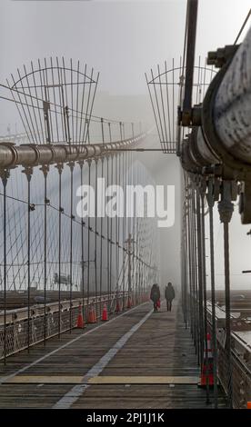 Brooklyn Bridge’s famous gothic towers are shrouded in a January fog ...
