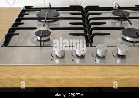 New gas stove close-up built into the kitchen furniture Stock Photo - Alamy