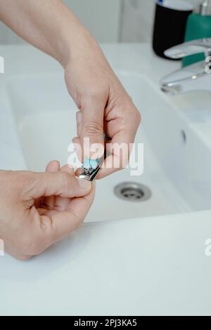 hand cutting fingernails Stock Photo - Alamy