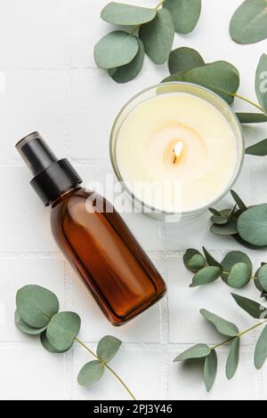 Cosmetic bottle with eucalyptus on white background. Close up, copy ...