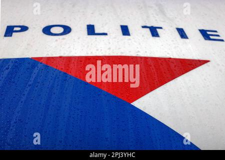 Logo and striping of the Dutch police (politie) on patrol car in the ...