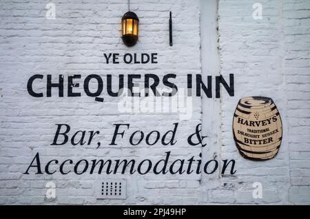 The name of the pub "Ye Olde Chequers Inn" hand painted on the side of ...