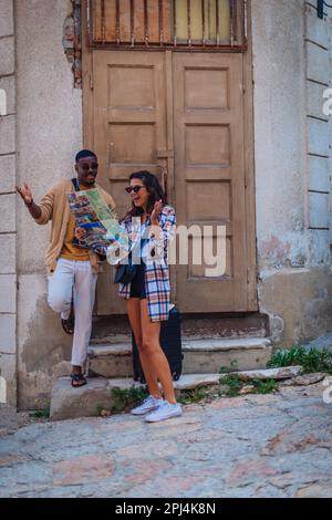 Cheerful young man found something good, smiling and looking through ...