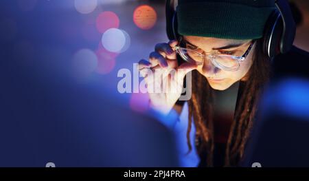 Hacker, woman in basement and laptop, coding and IT with code overlay ...