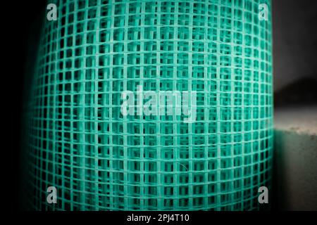 Plastic reinforcing facade mesh in green color close-up. Plaster mesh ...