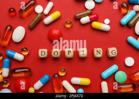 Flat lay composition with word Doping, tennis balls and drugs on black ...