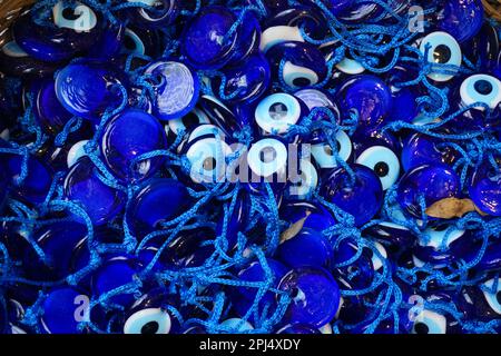 blue evil eye beads hung on a tree Stock Photo - Alamy