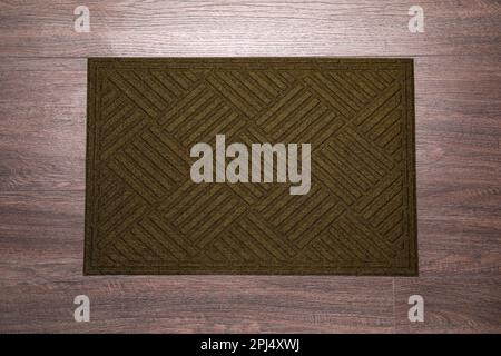 Door mat on wooden floor Stock Photo - Alamy