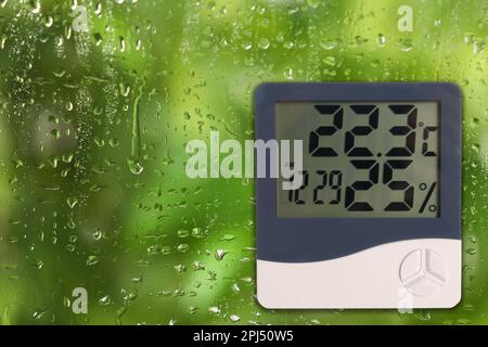 Digital hygrometer with thermometer on small table in children's room ...