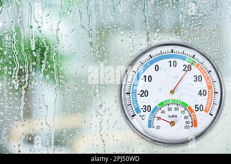 Mechanical hygrometer with thermometer on glass with water drops Stock ...