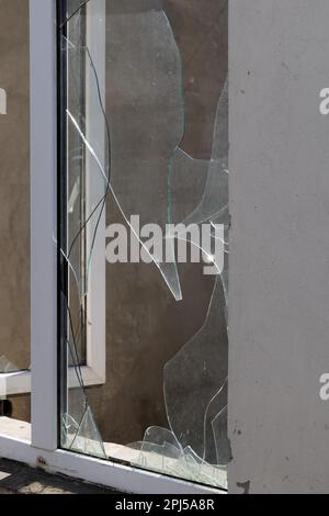 real gun bullet broken window glass Stock Photo - Alamy
