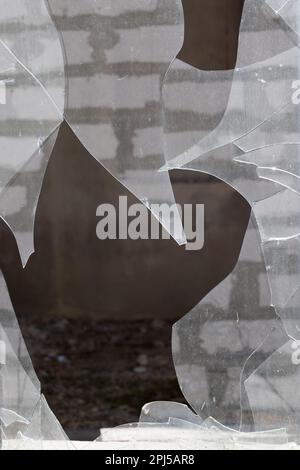 real gun bullet broken window glass Stock Photo - Alamy