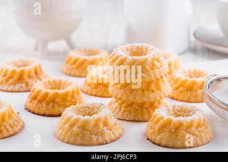 Small sponge cakes with cottage cheese. Ring cakes on white background ...