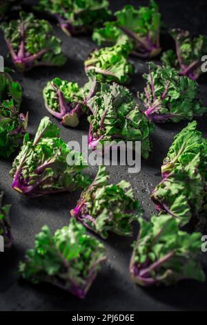 Kalette, kale sprouts or flower sprouts on black background. Hybrid ...