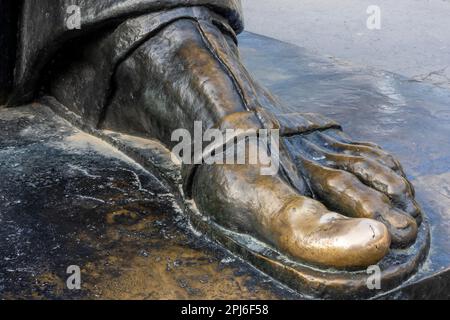 The huge foot of the bronze sculpture of Gregory of Nin and the shiny ...