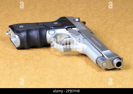 bullet 9mm parabellum and Beretta 92FS, M9 gun on brown paper ...