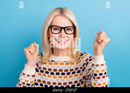 Photo of pretty lucky lady dressed green shirt smiling rising fists ...