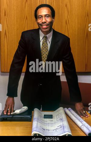 1996 HISTORICAL MALE OFFICE WORKER WITH CONSTRUCTION PLANS Stock Photo ...