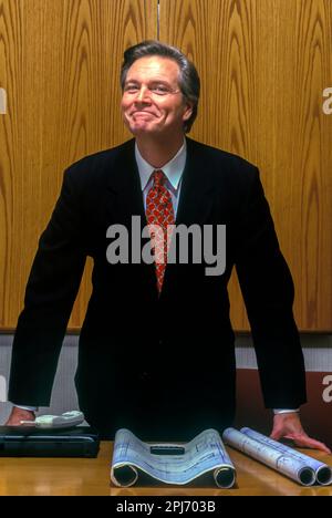 1996 HISTORICAL MALE OFFICE WORKER WITH CONSTRUCTION PLANS Stock Photo ...