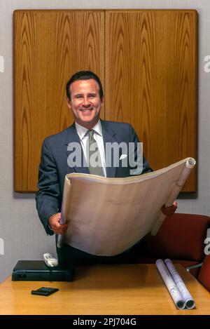 1996 HISTORICAL MALE OFFICE WORKER WITH CONSTRUCTION PLANS Stock Photo ...