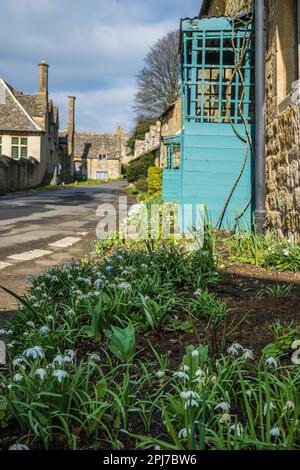 Iconic row of medieval stone built cottages in the picturesque village ...