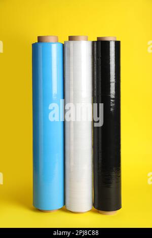Rolls of different stretch wrap on yellow background. Space for text ...