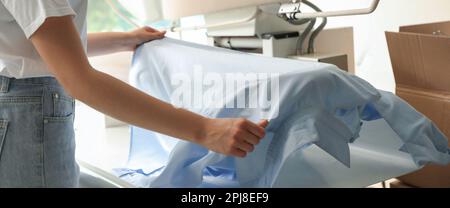 Closeup view of female worker ironing laundry, banner design. Dry ...