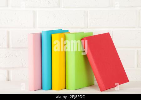 Multi coloured school books on a white background with copy space. Top ...