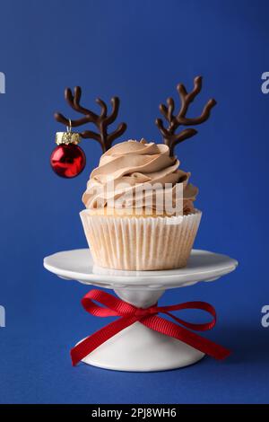 Christmas sweet cupcake bauble on dark green background Stock Photo - Alamy